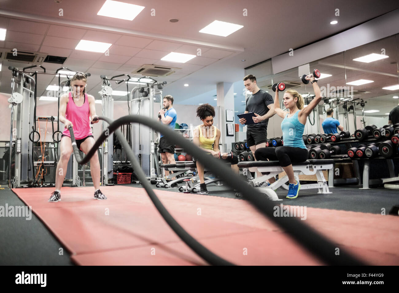 Fit people working out in weights room Stock Photo - Alamy