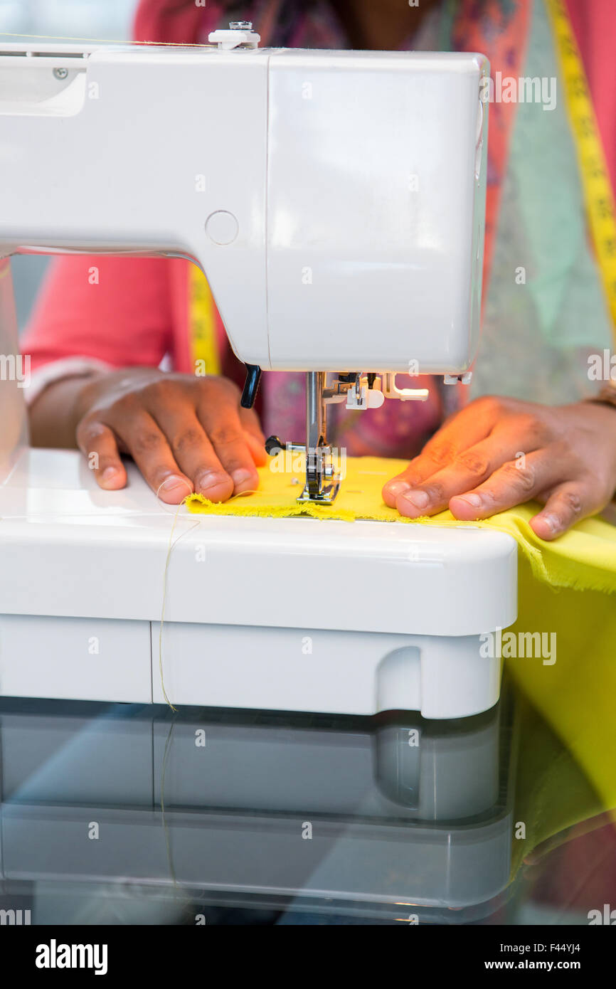Fashion designer using sewing machine Stock Photo - Alamy