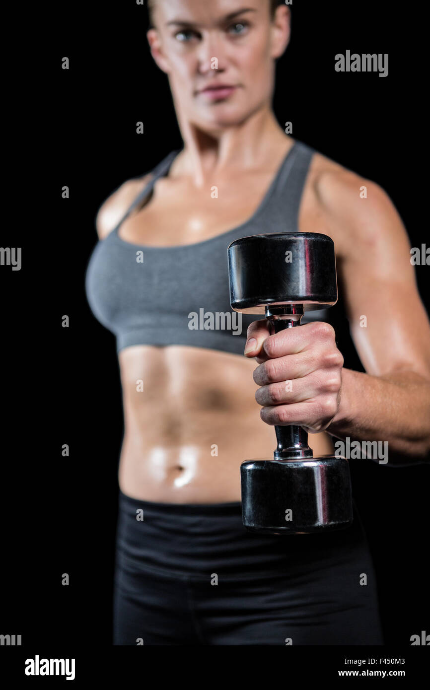 Muscular woman lifting heavy dumbbells Stock Photo - Alamy