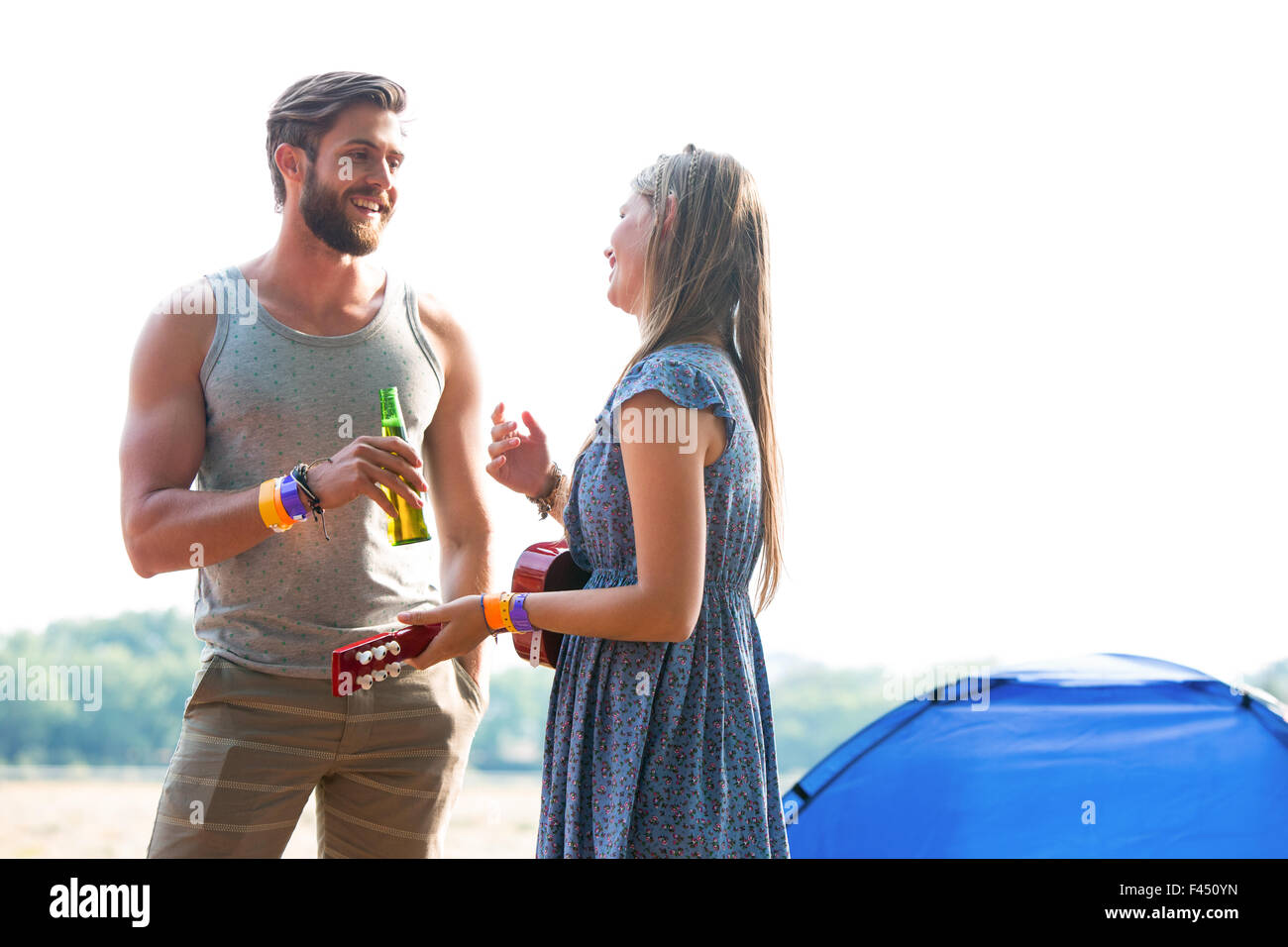 Two friends chatting in campsite Stock Photo - Alamy