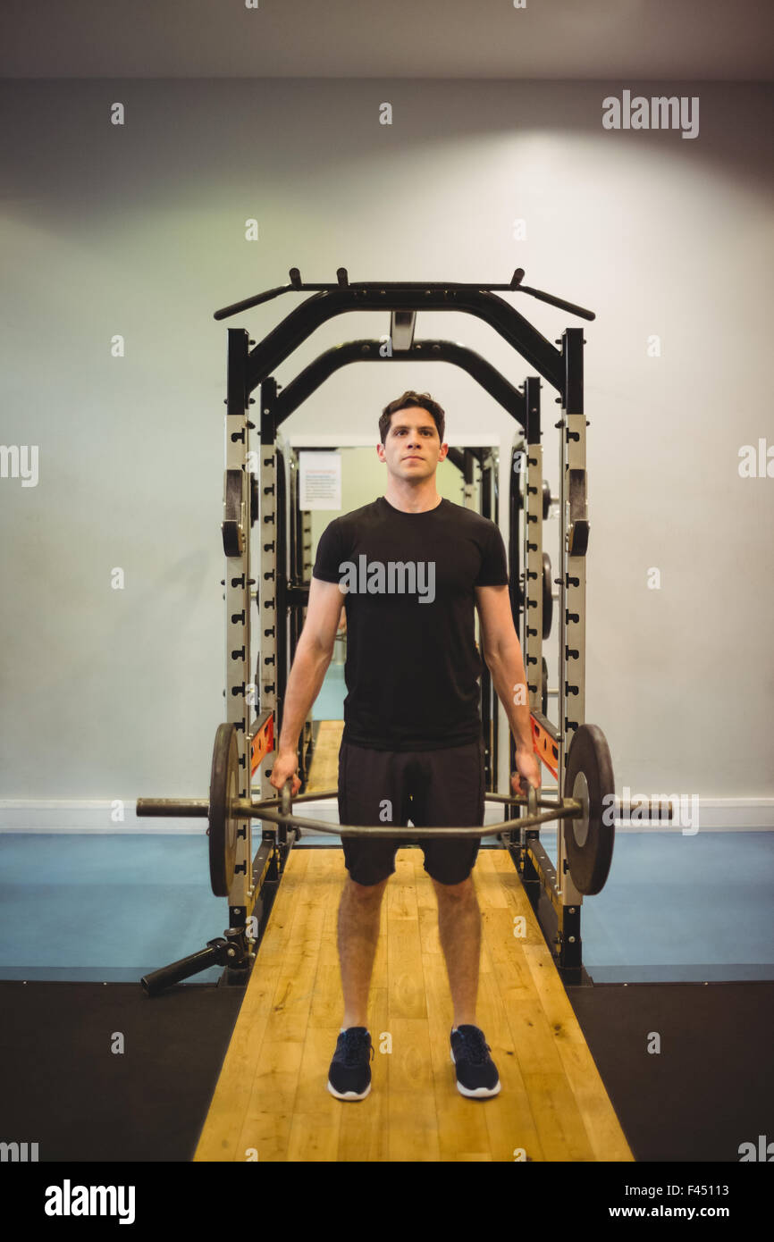 Fit man lifting heavy barbell Stock Photo - Alamy