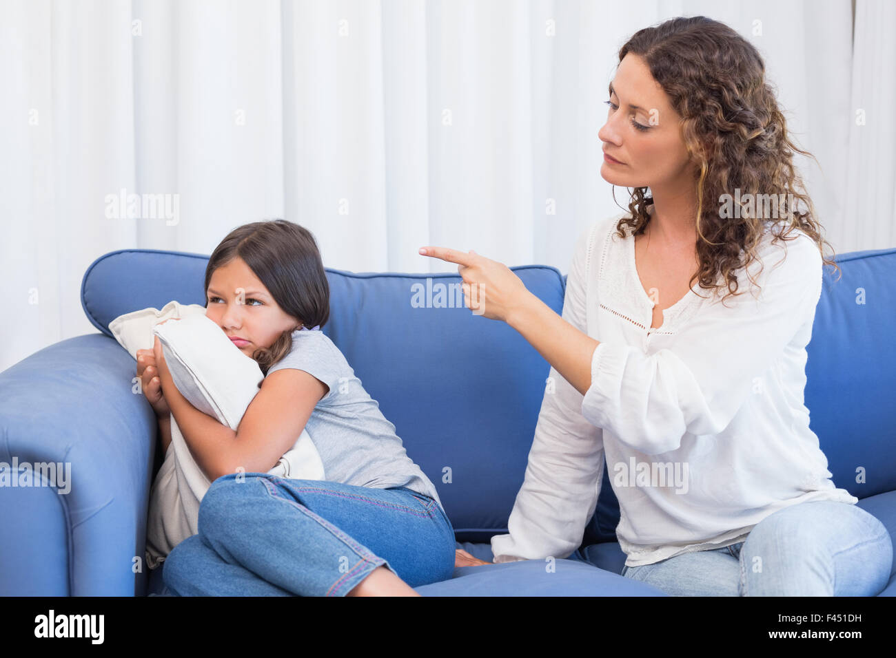 Upset mother looking at her daughter Stock Photo - Alamy