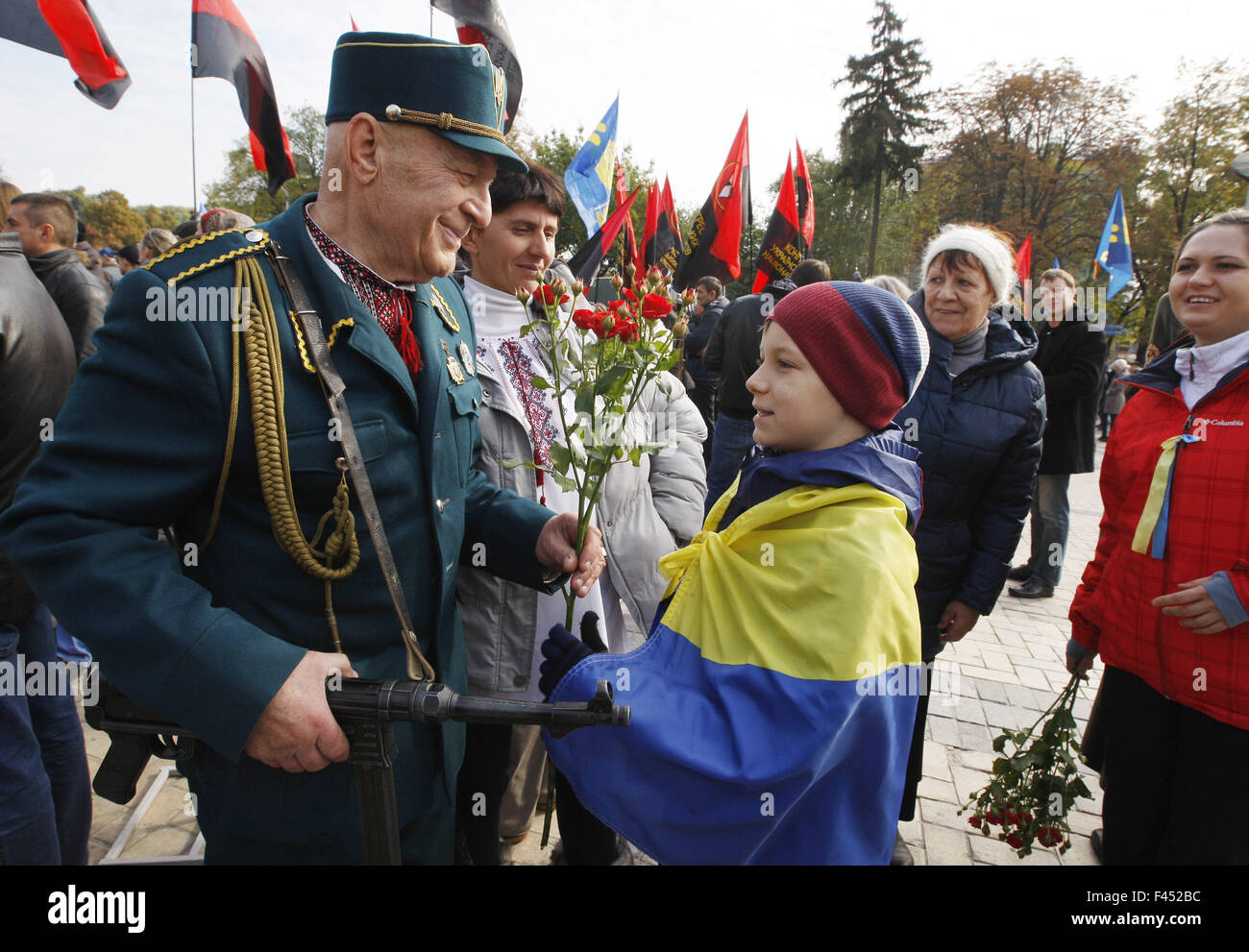 Kiev, Ukraine. 14th Oct, 2015. The boy gives flowers to the veteran UPA ...