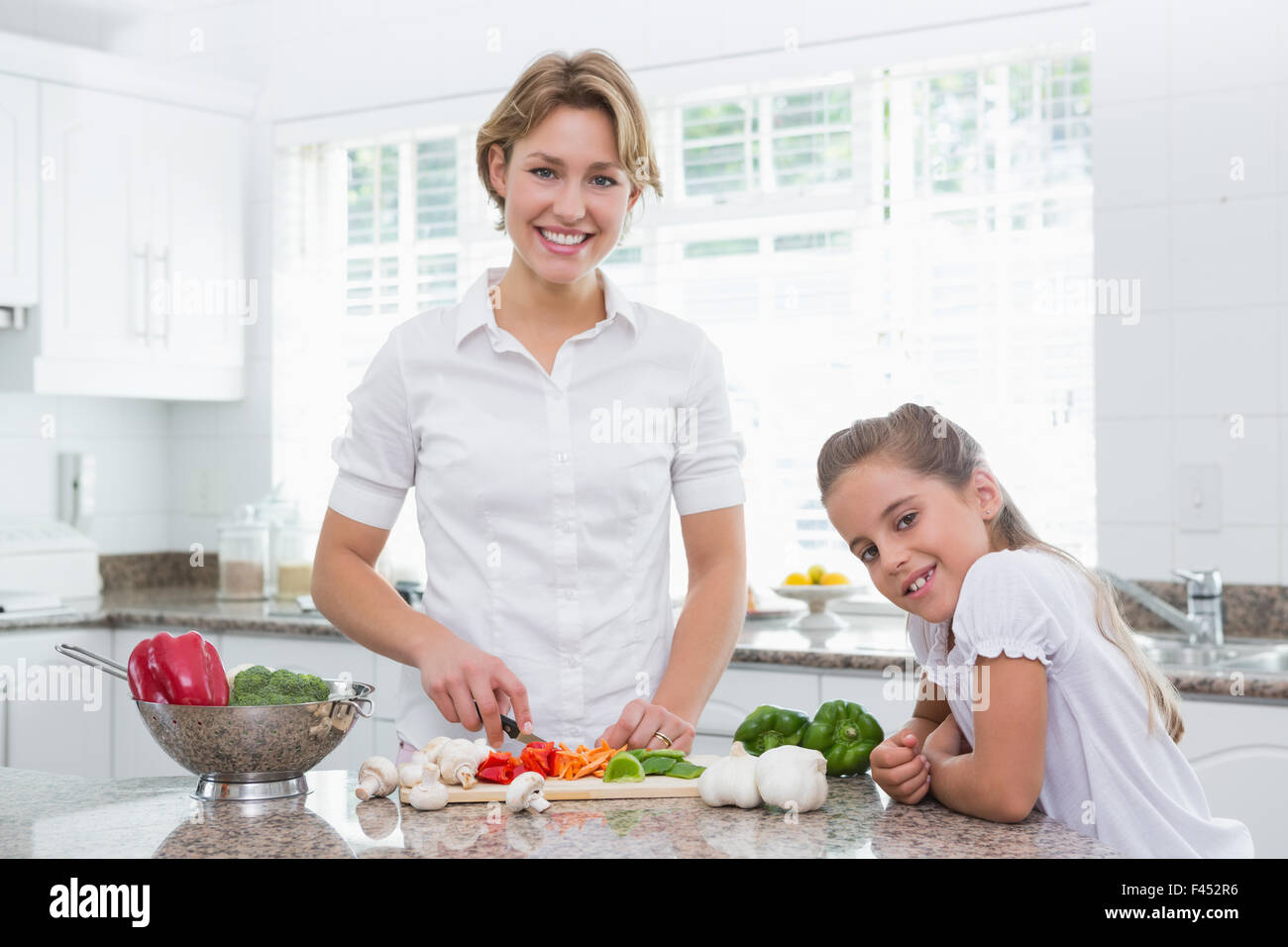 Mother and daughter preparing vegetables Stock Photo - Alamy