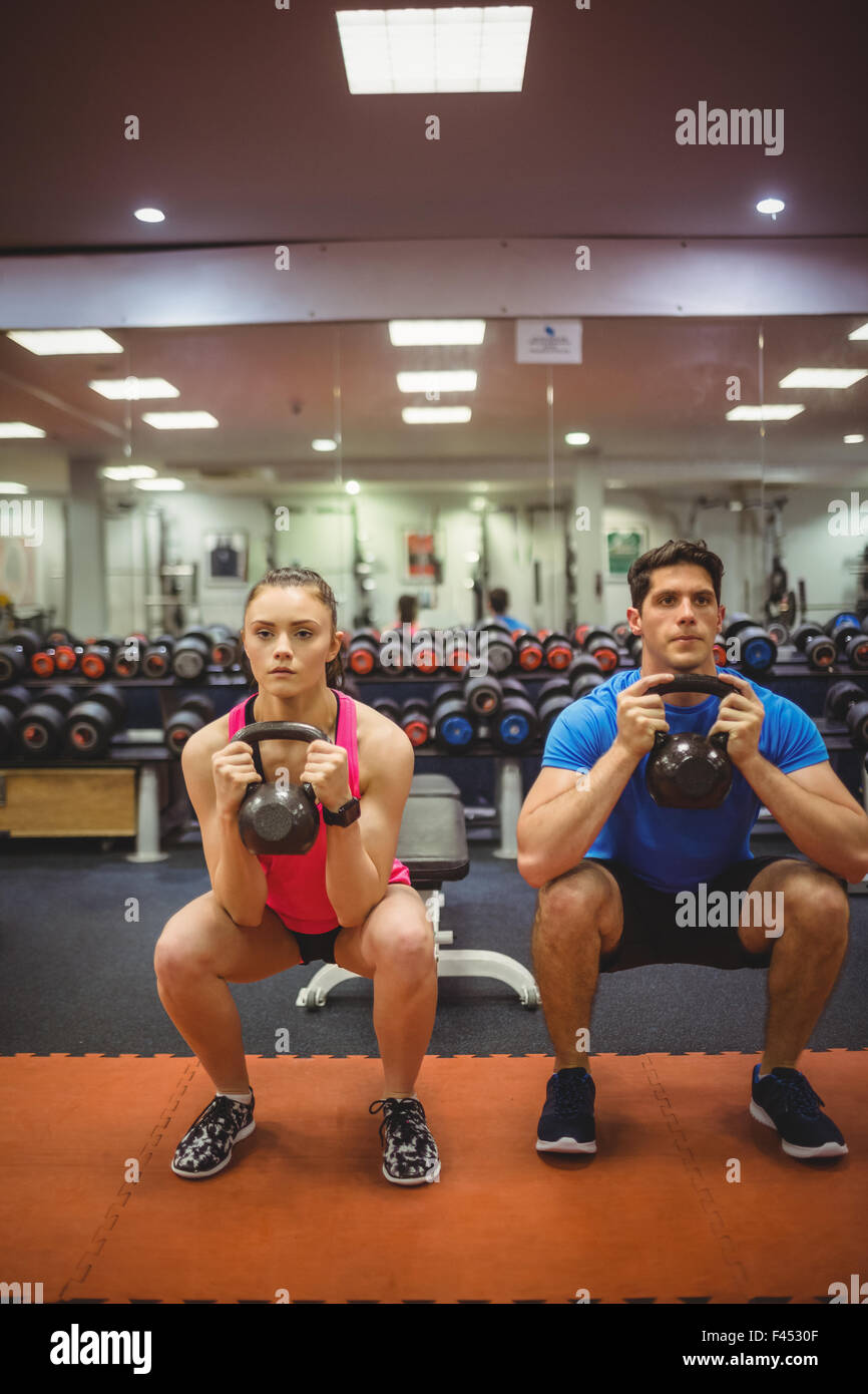 Fit couple working out in weights room Stock Photo - Alamy