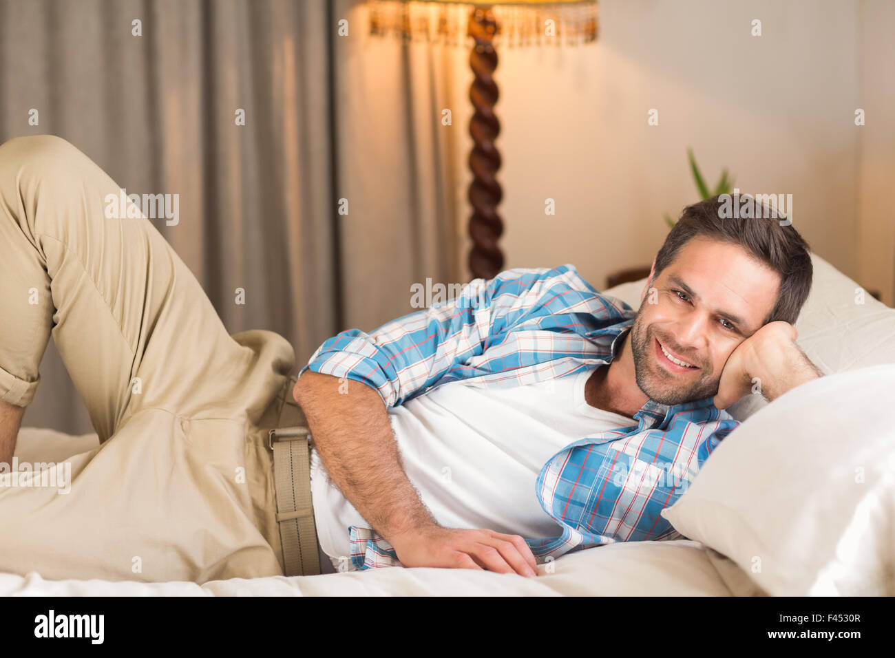 Handsome man relaxing on bed hi-res stock photography and images - Alamy
