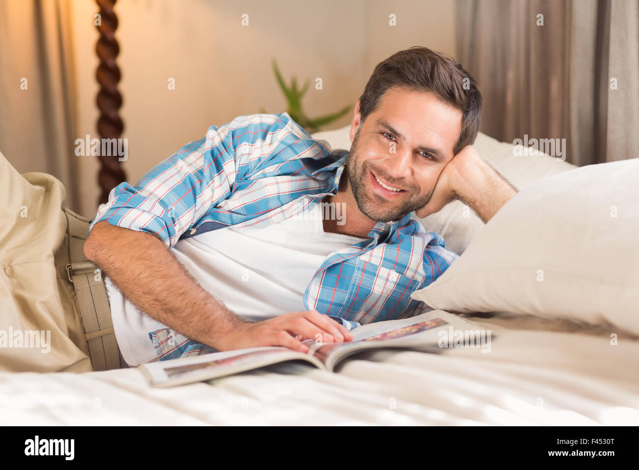 Handsome man relaxing on his bed Stock Photo - Alamy