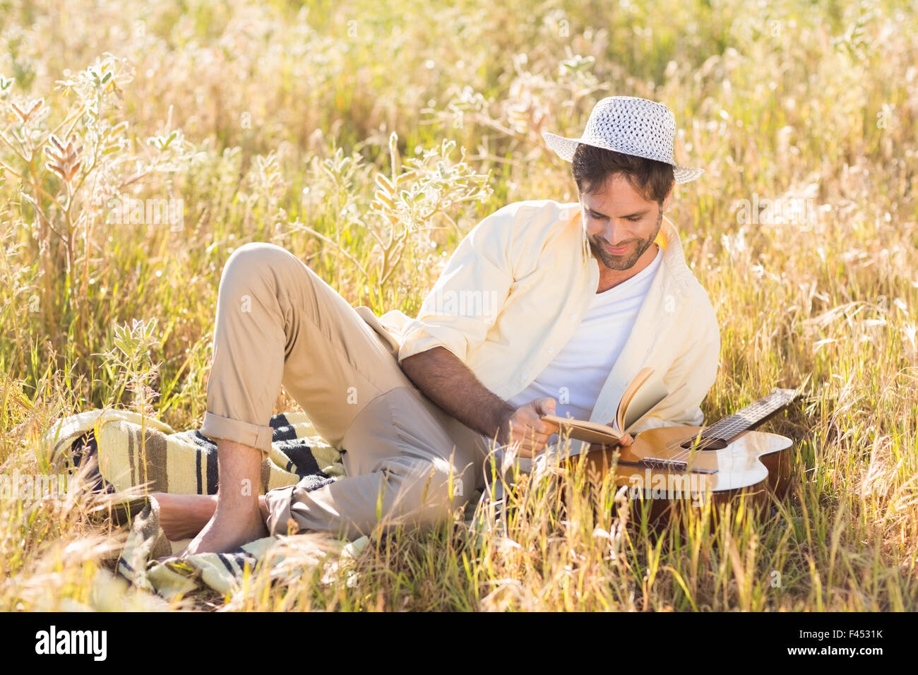 Happy man reading a book Stock Photo - Alamy
