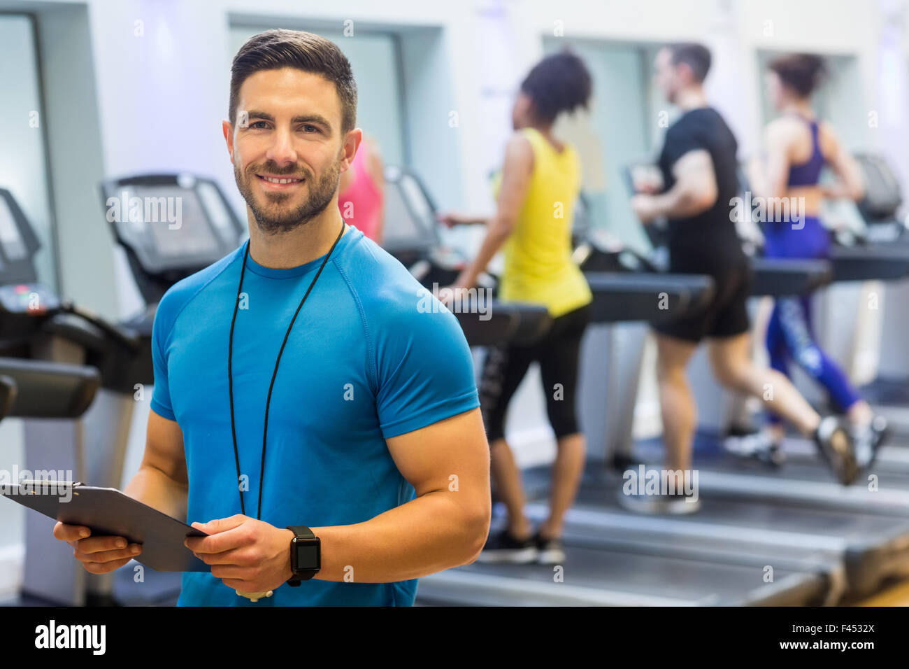 Handsome trainer smiling at camera Stock Photo - Alamy