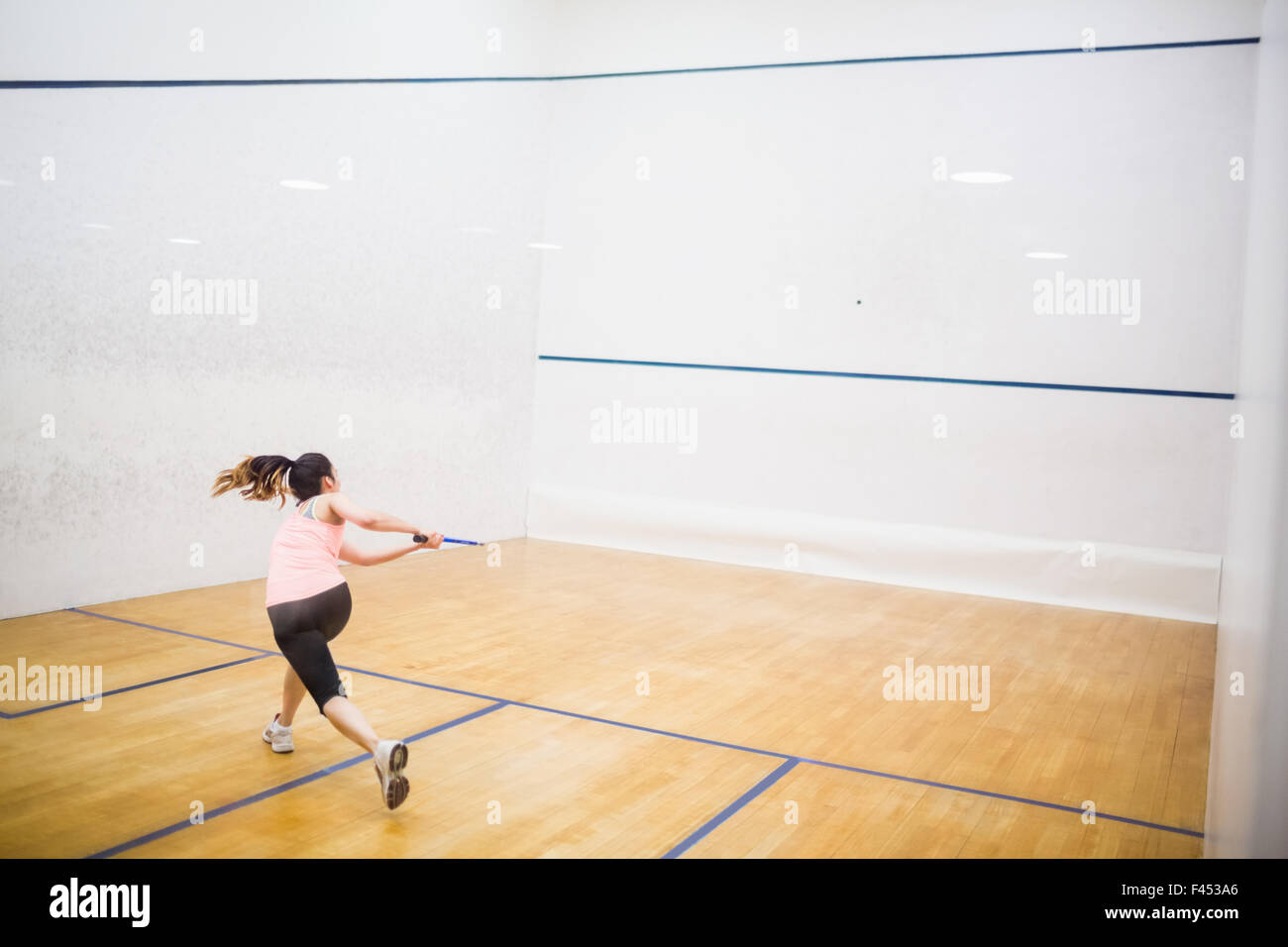 Woman playing a game of squash Stock Photo - Alamy