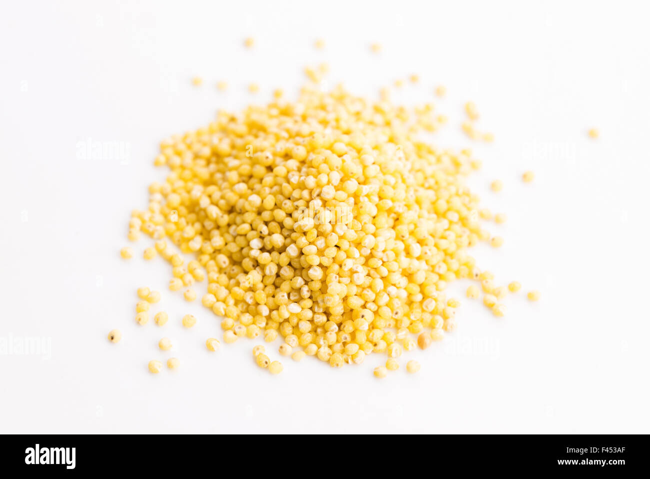 Heap of millet groats on white Stock Photo - Alamy