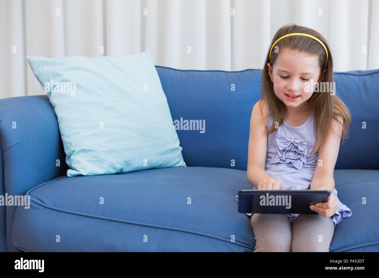 Little girl using tablet pc Stock Photo - Alamy