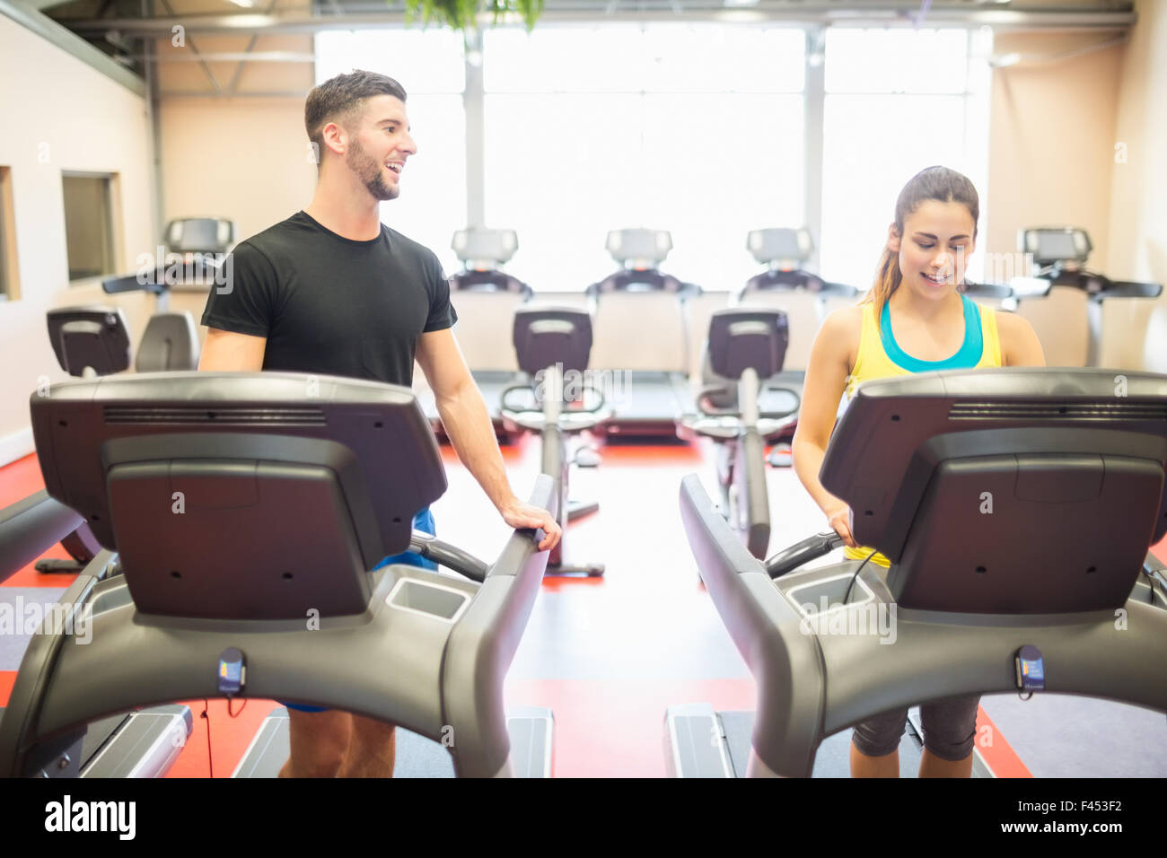 Man and woman using treadmills Stock Photo - Alamy