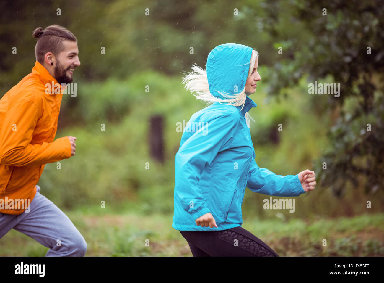 Happy couple running on a hike Stock Photo - Alamy