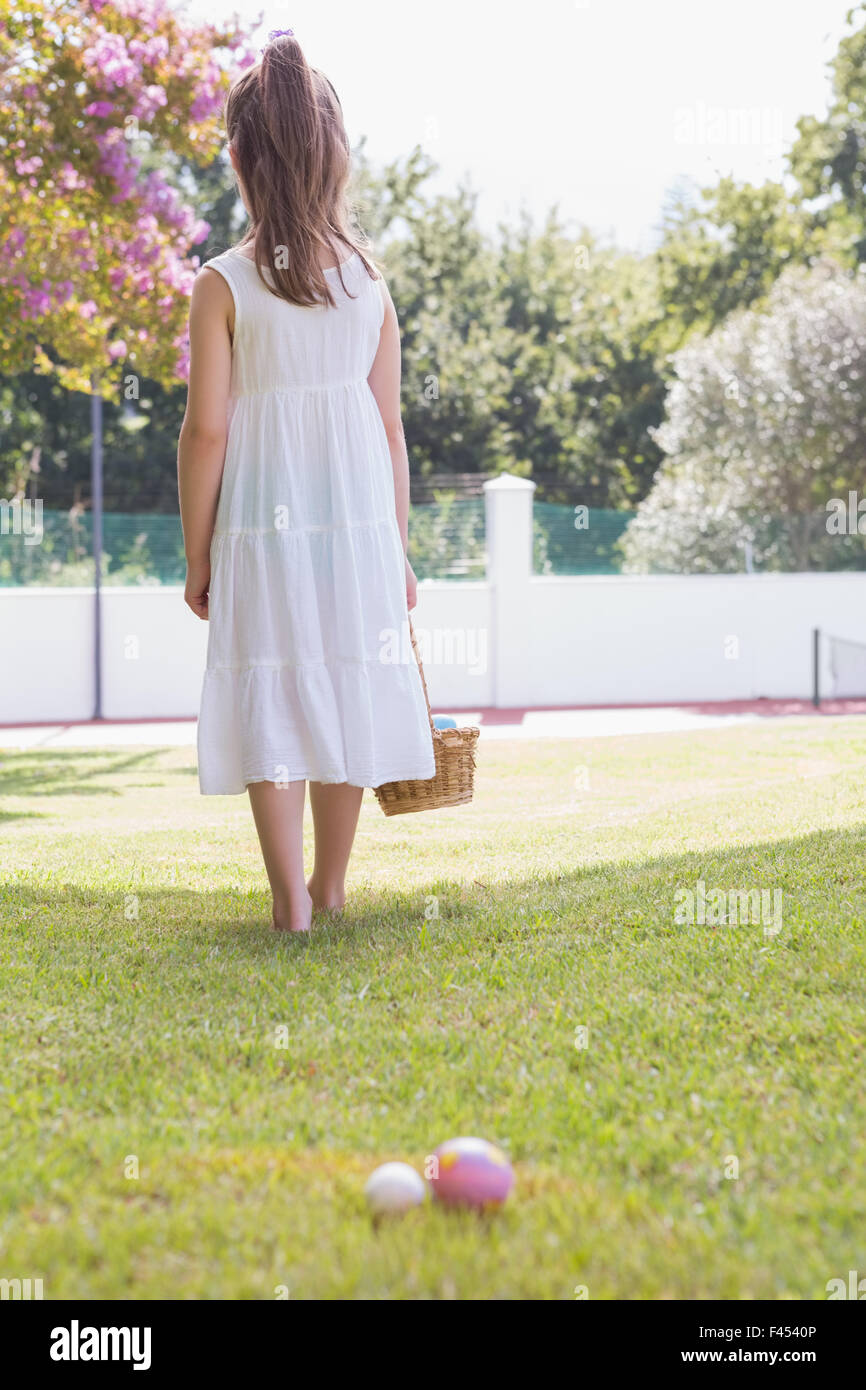 Little girl collecting easter eggs Stock Photo - Alamy
