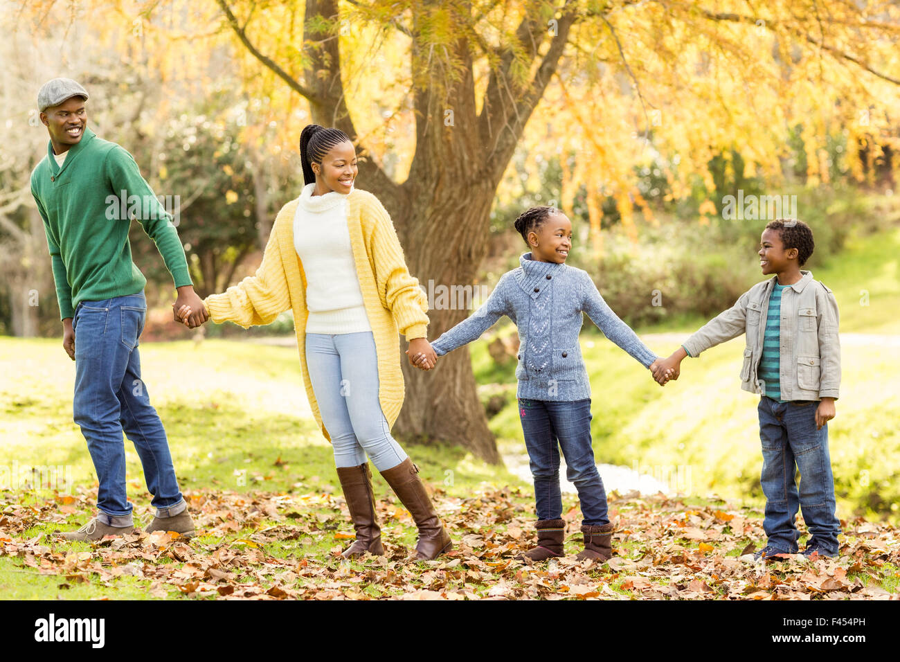 Young smiling family giving their hands to others Stock Photo - Alamy