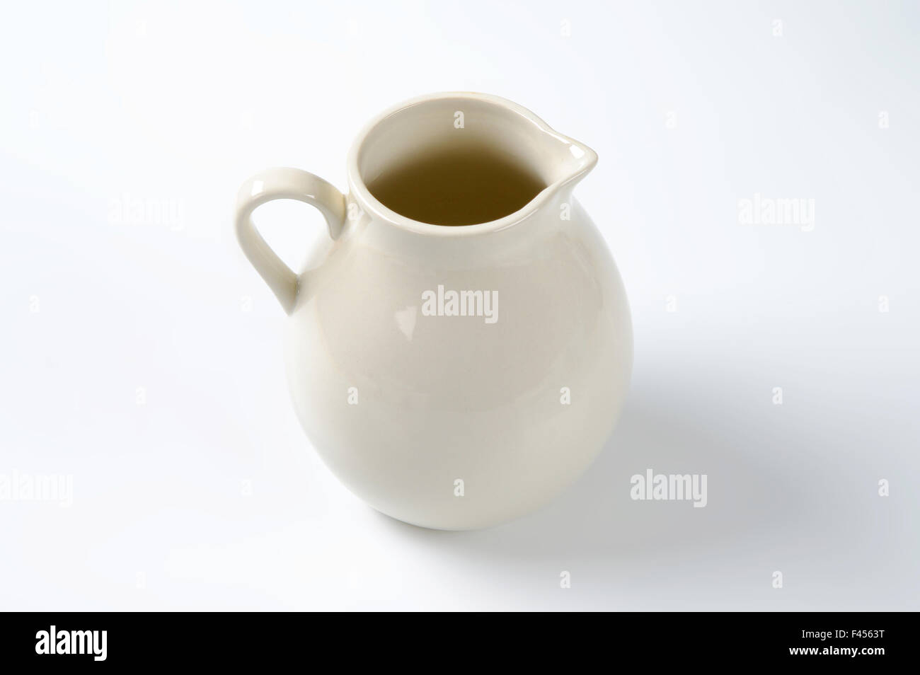 empty milk jug on white background Stock Photo - Alamy