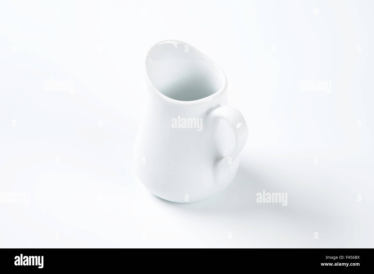 white milk jug on white background Stock Photo - Alamy