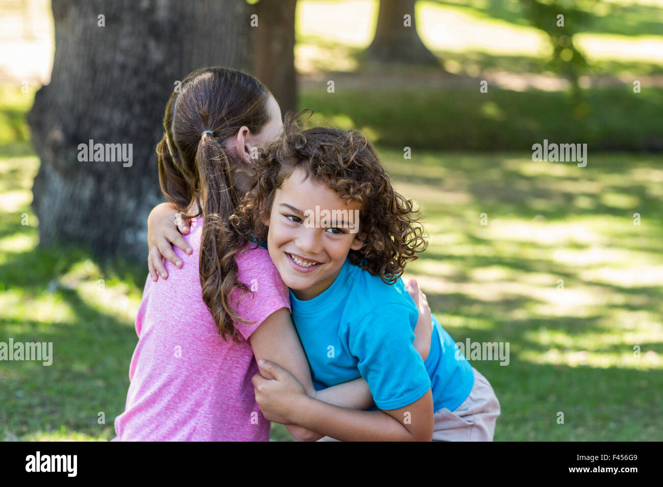 Little siblings smiling at camera Stock Photo - Alamy