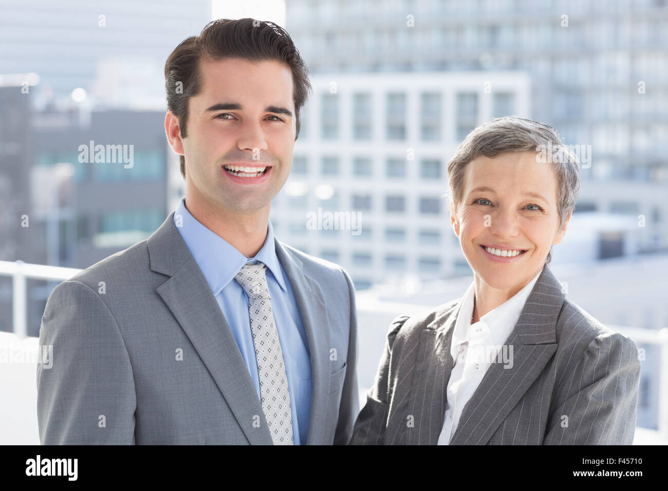 Business colleagues smiling at camera Stock Photo - Alamy