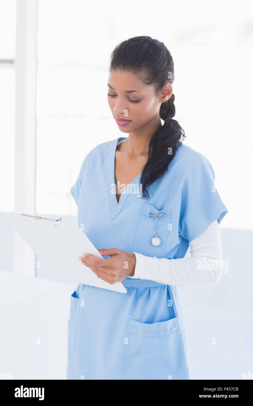 Beautiful doctor reading files Stock Photo - Alamy