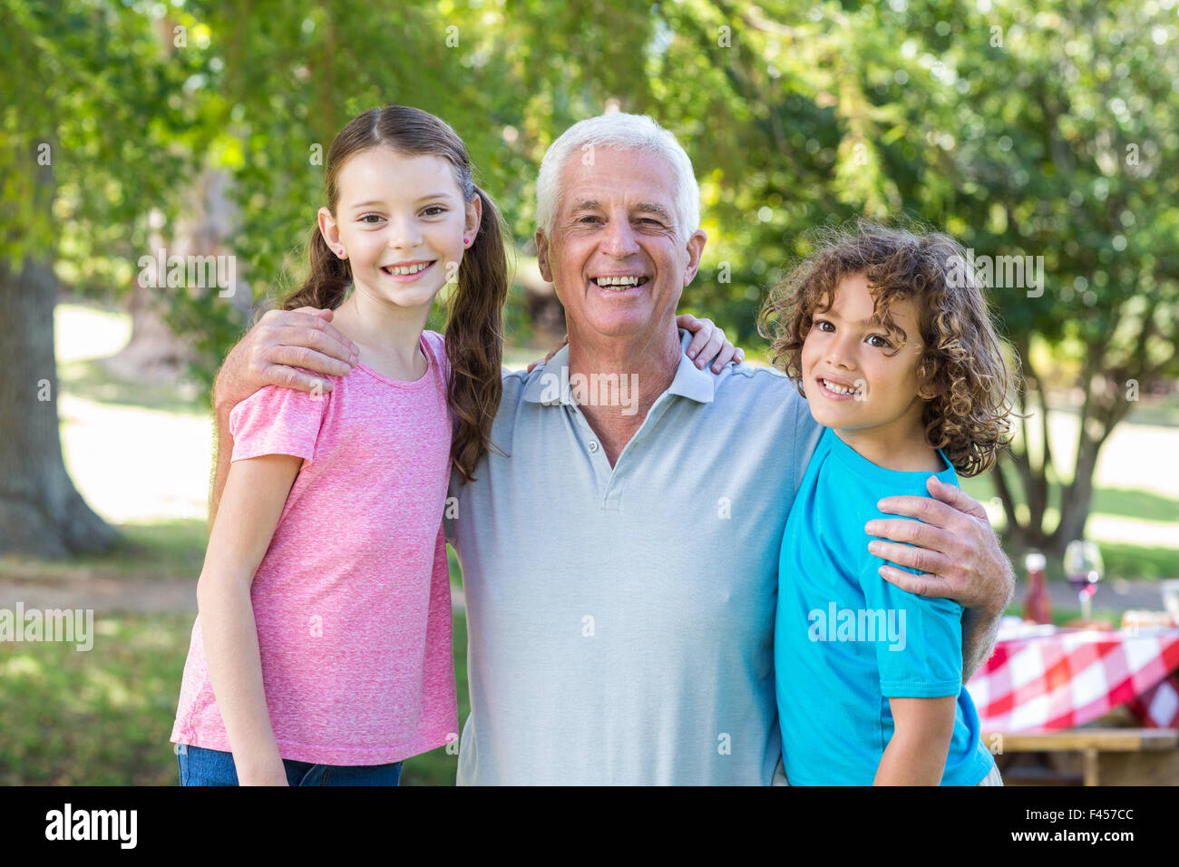 Extended family smiling in the park Stock Photo - Alamy