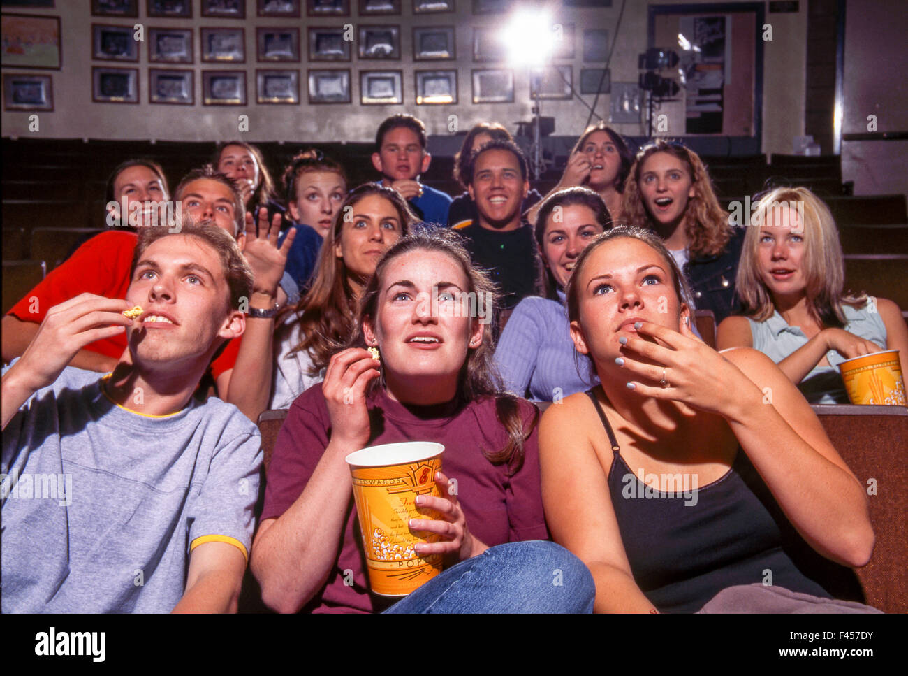Showing various emotions, a multiracial group of high school students ...
