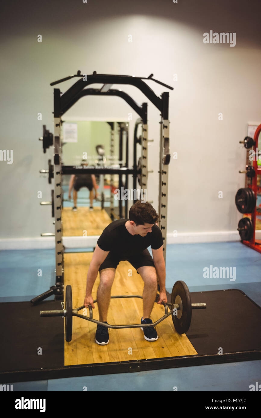 Fit man lifting heavy barbell Stock Photo - Alamy