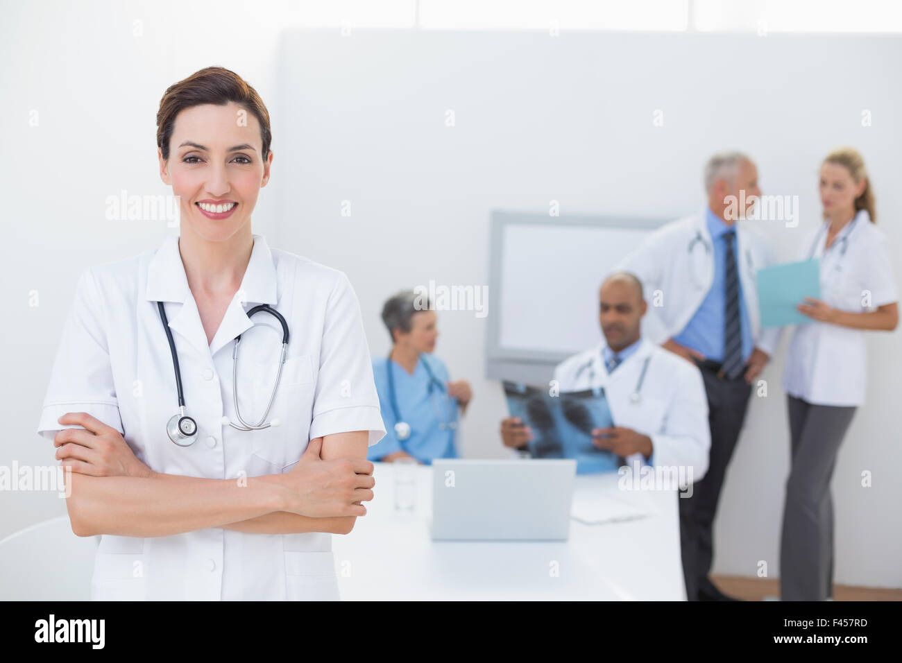 Doctor looking xray smiling camera hi-res stock photography and images ...