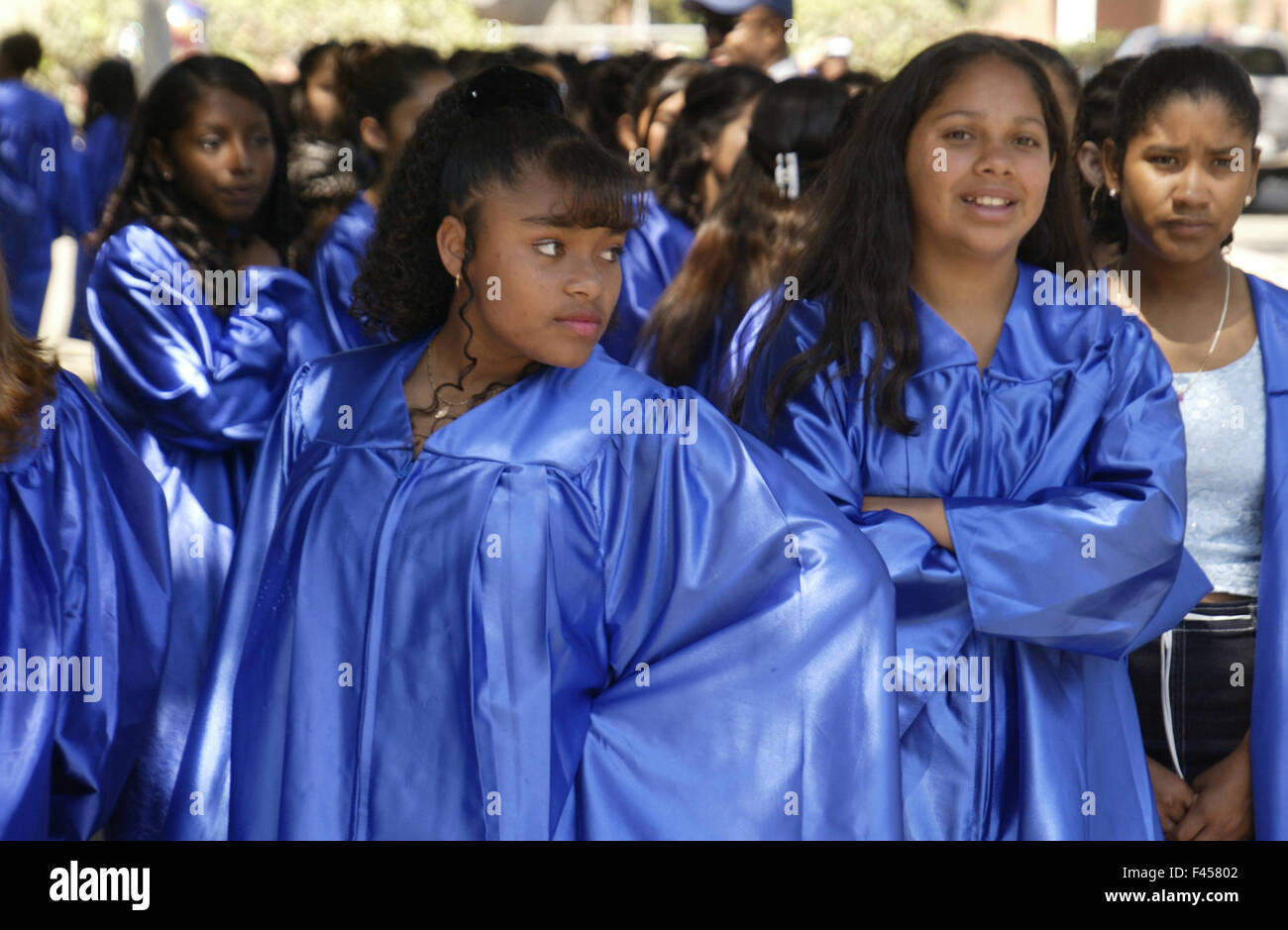 Hispanic and African American middle school girls wearing blue ...