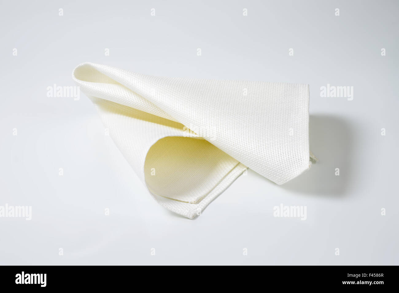 white folded napkin on white background Stock Photo - Alamy