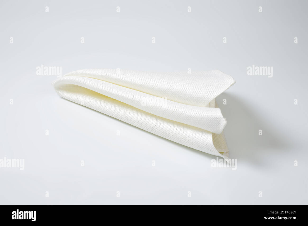 white folded napkin on white background Stock Photo - Alamy