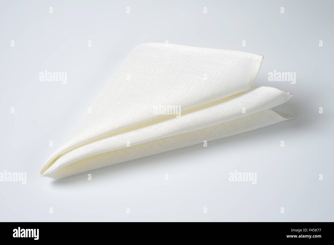 white folded napkin on white background Stock Photo - Alamy