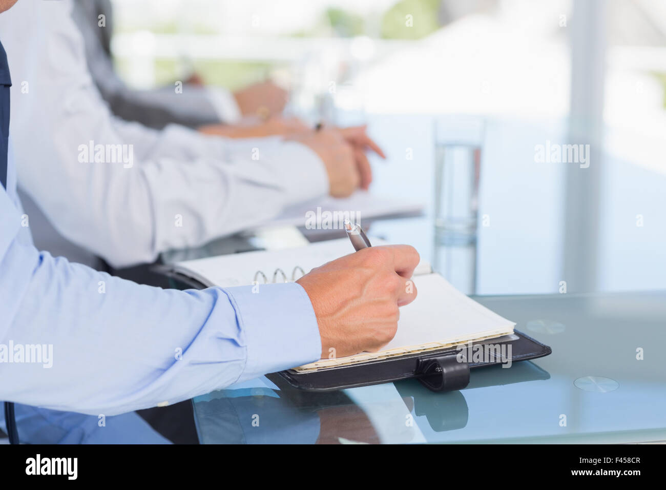 Listening colleagues taking notes hi-res stock photography and images ...