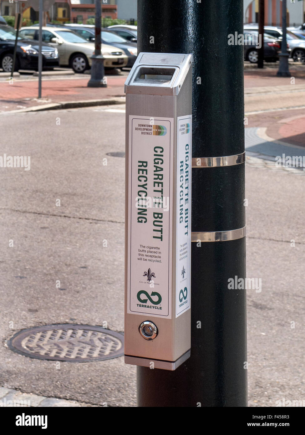 A cigarette butt receptacle is mounted on a post on a street in New ...