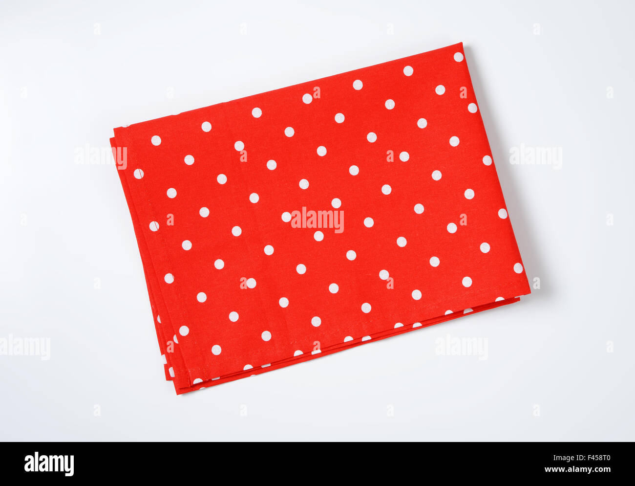 red and white dotted place mat on white background Stock Photo - Alamy