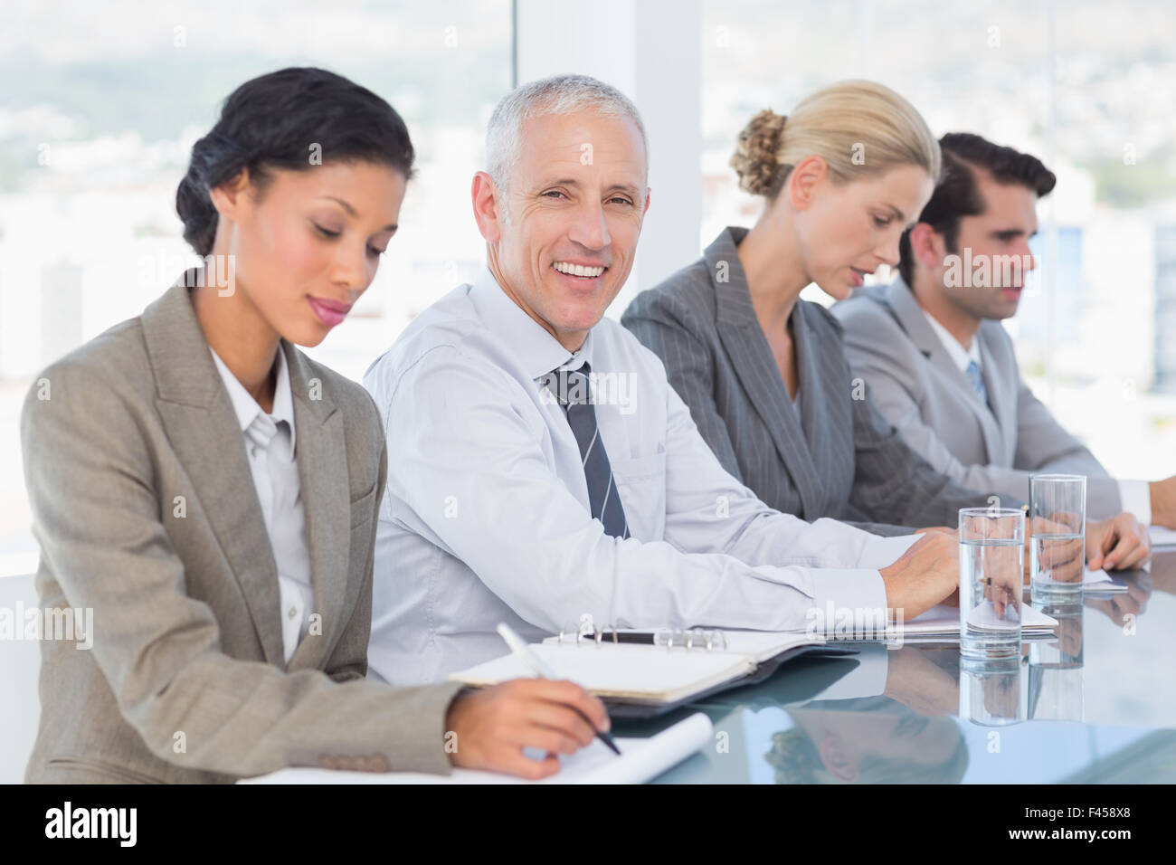 Business team taking notes during conference Stock Photo - Alamy