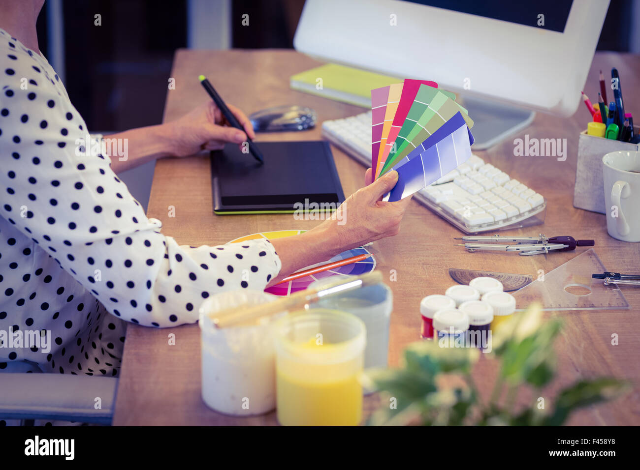 Interior designer working at desk Stock Photo - Alamy
