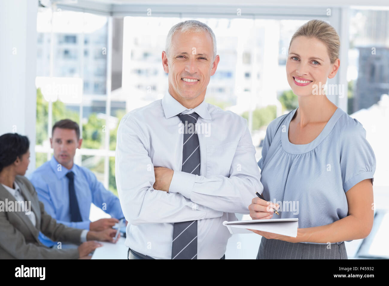 Colleagues speaking about work Stock Photo - Alamy