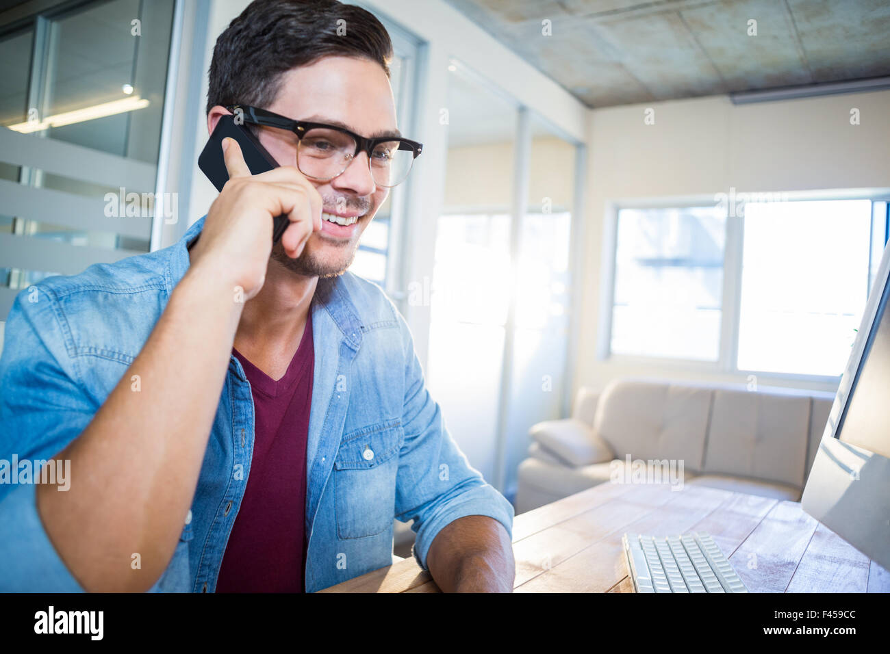 Casual businessman speaking at the phone Stock Photo - Alamy