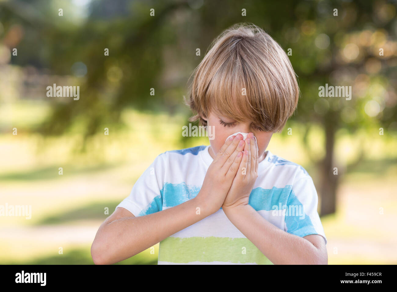 Little boy blowing his nose Stock Photo - Alamy