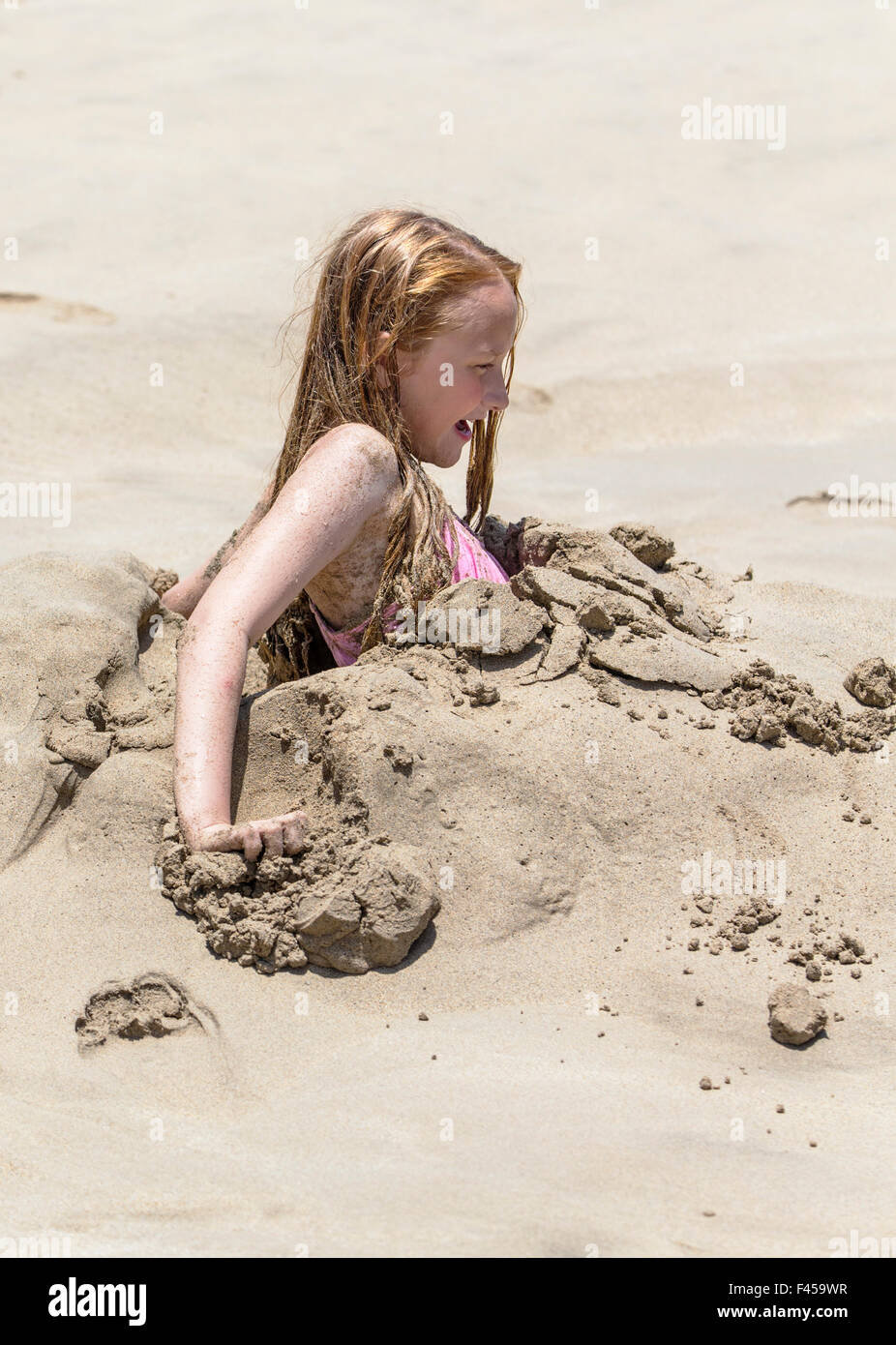 Young girl playing in sand, Hapuna Beach, Kohala Coast, Hawai'i, USA ... Young girl playing in sand, Hapuna Beach, Kohala Coast, Hawai'i, USA ...