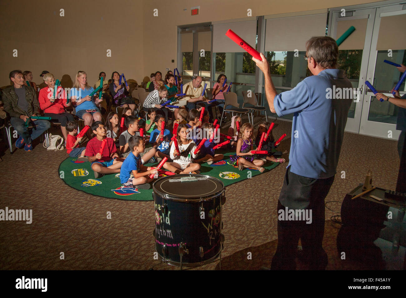A multiracial children's rhythm band plays tuned percussion tubes ...
