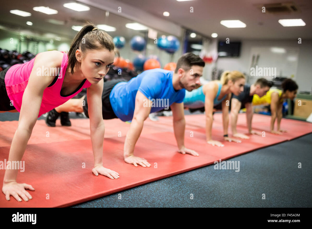 Fit people working out in fitness class Stock Photo - Alamy