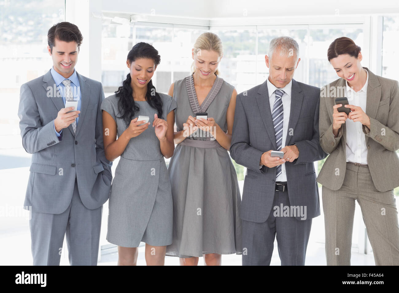 Employees using their mobile phone Stock Photo - Alamy