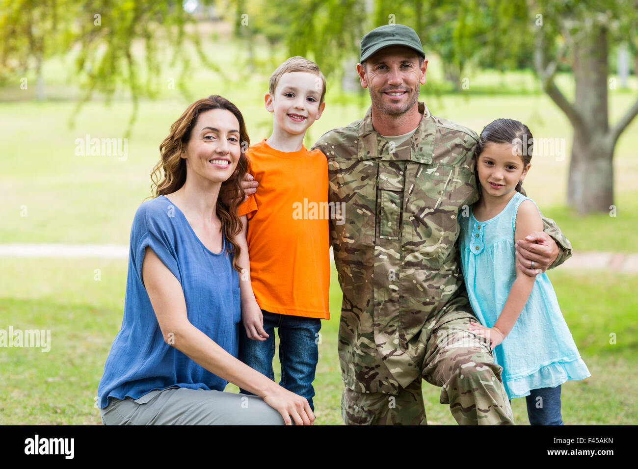 Handsome soldier reunited with family Stock Photo - Alamy