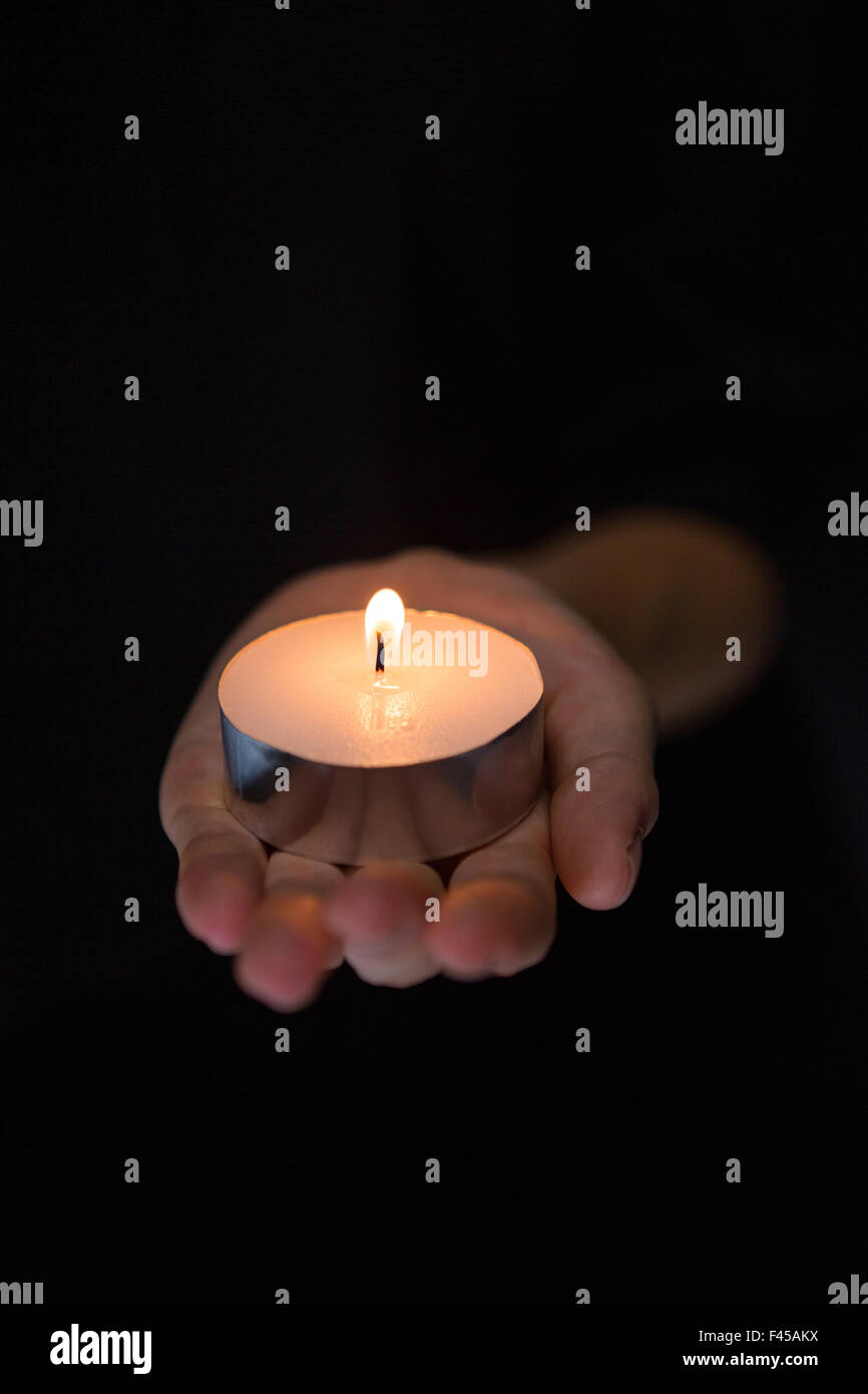 Hand holding candle Stock Photo - Alamy