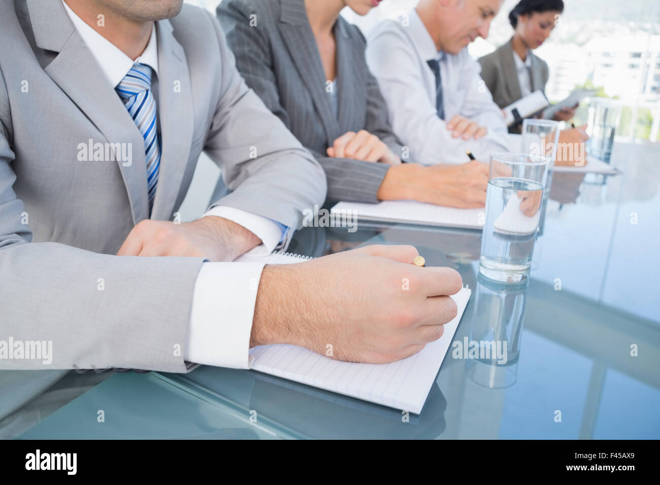 Business team taking notes during conference Stock Photo - Alamy