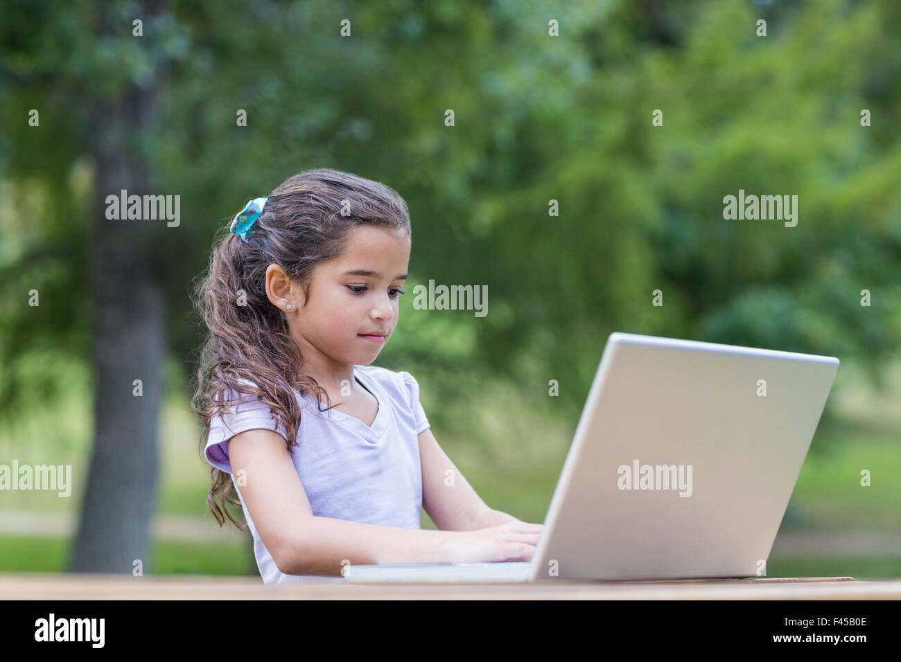 Little girl using her laptop Stock Photo - Alamy