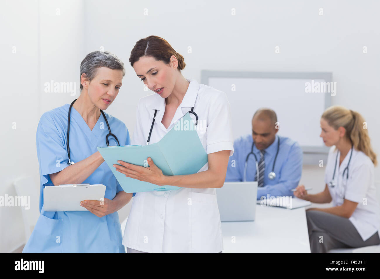 Team of doctors working on their files Stock Photo - Alamy